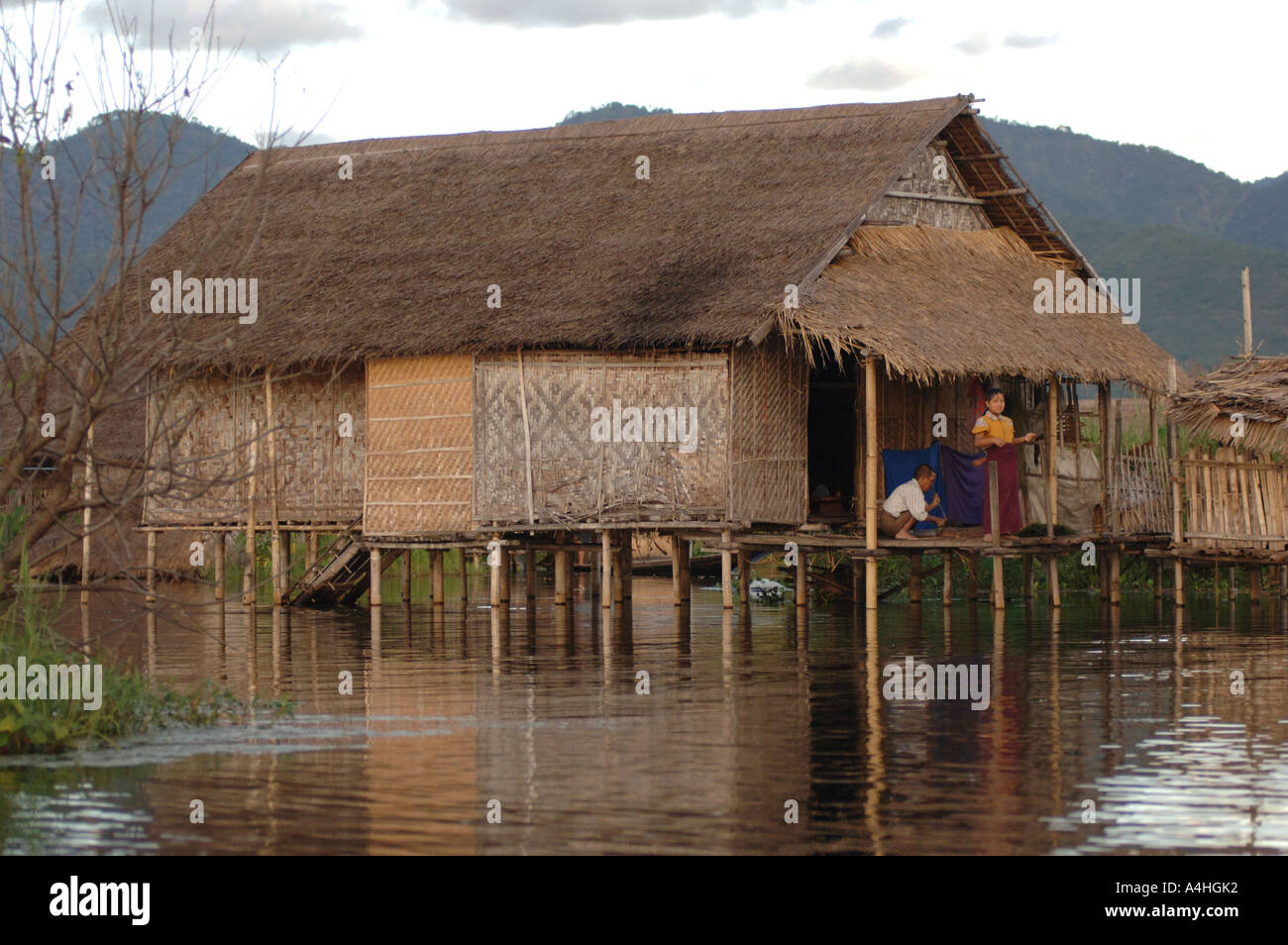 Two people standing outside their house on Myanmar Inle Lake Burma ...