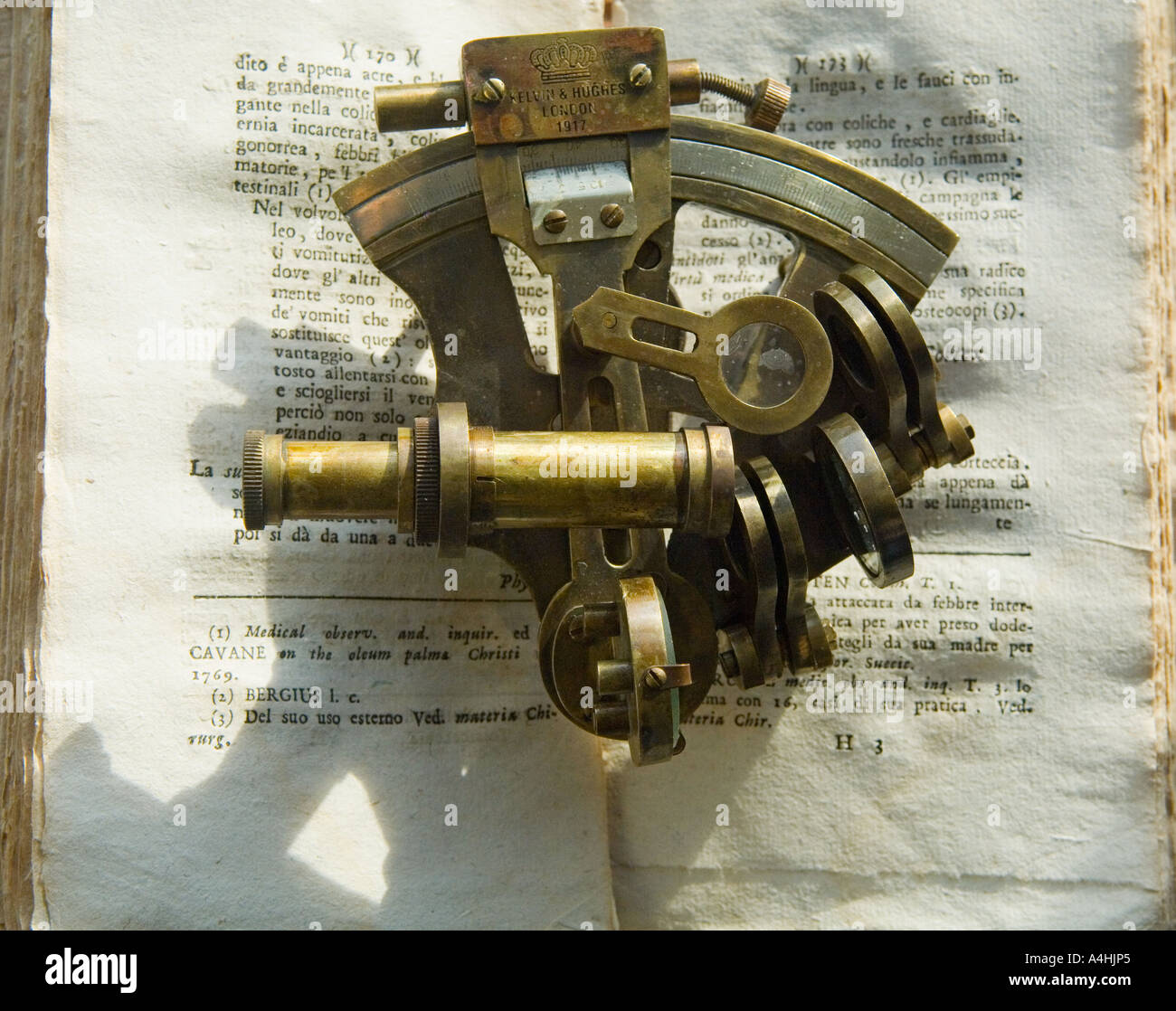 Sextant resting on an open antique book Stock Photo - Alamy