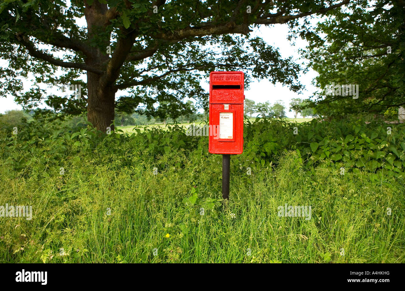 Red Postbox in rural environment Stock Photo - Alamy