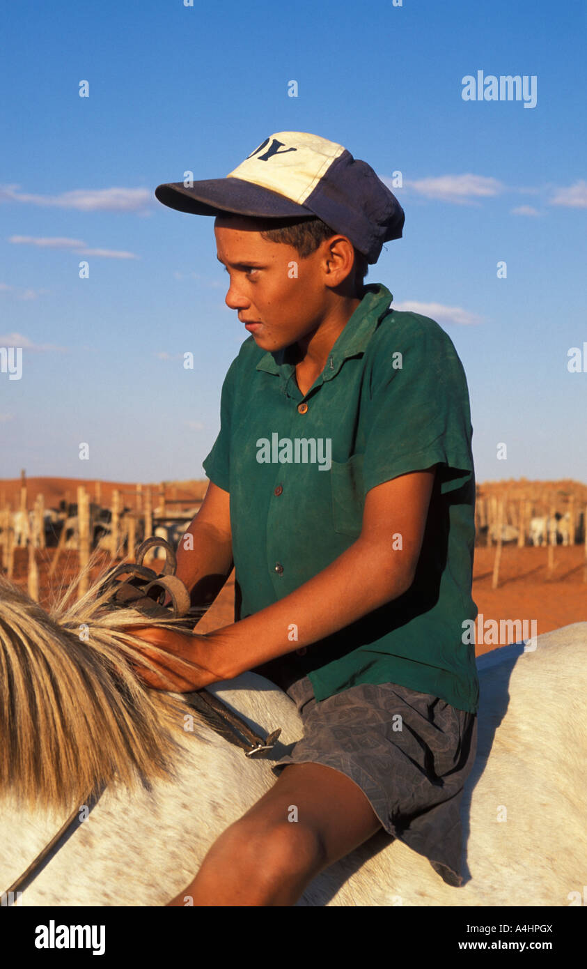coloured boy on horseback in a sheep farm in the Kalahari Northern Cape ...