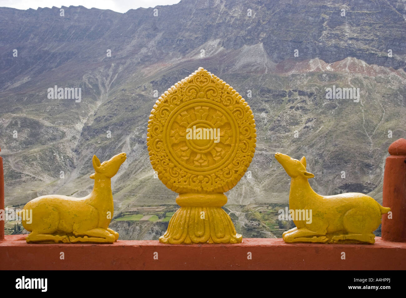 Buddhist wheel and deer symbols on top of roof of a monastery near the ...