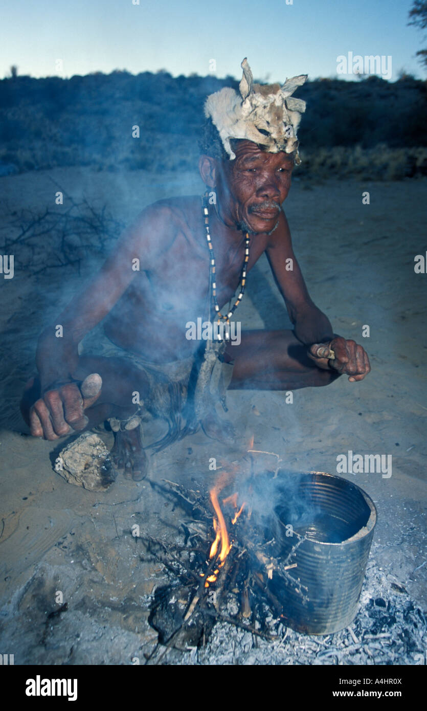 Bushman San sitting at a fire Kalahari Northern Cape South Africa Stock ...
