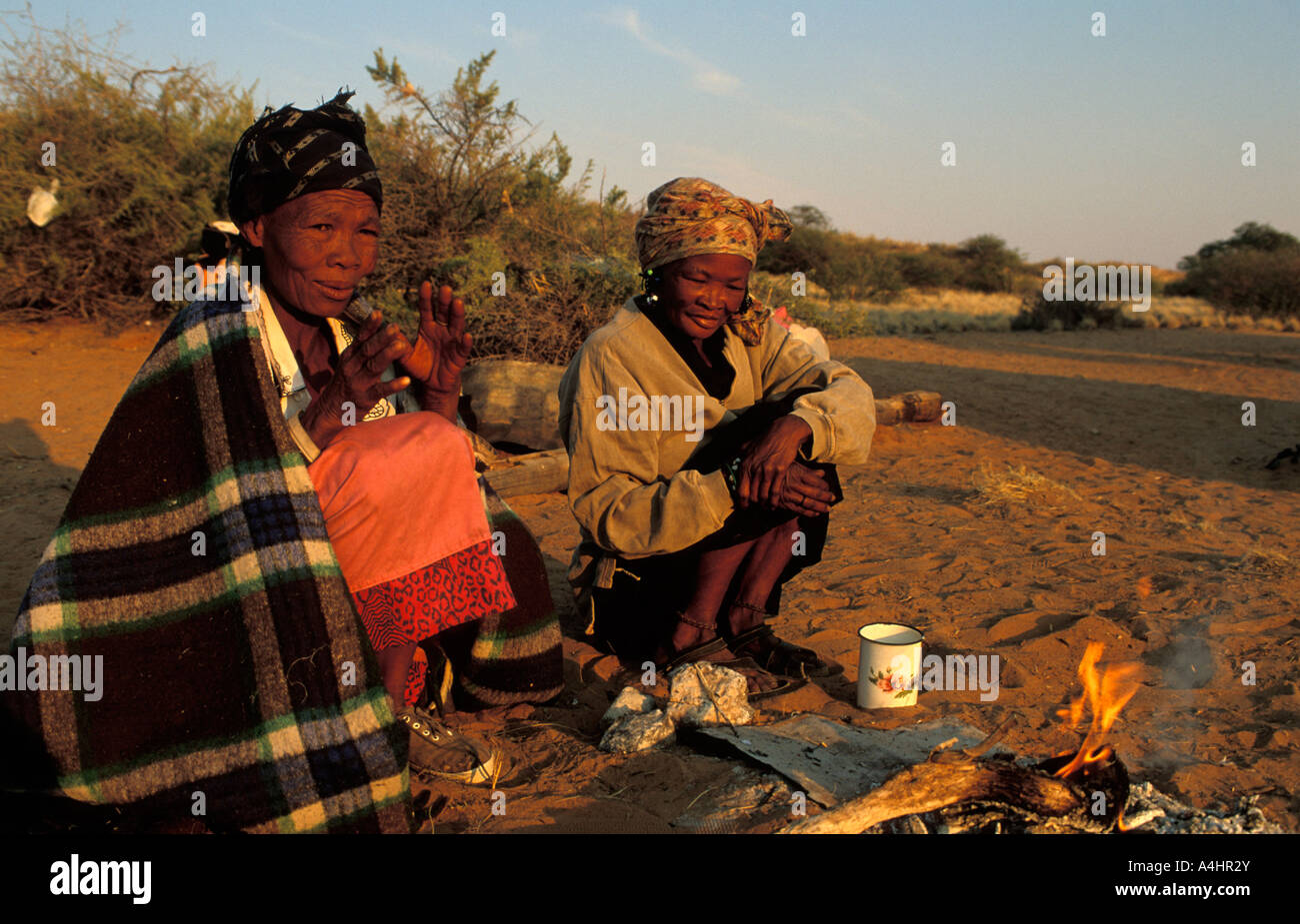 Bushman San women sitting at a fire Kalahari Northern Cape South Africa ...