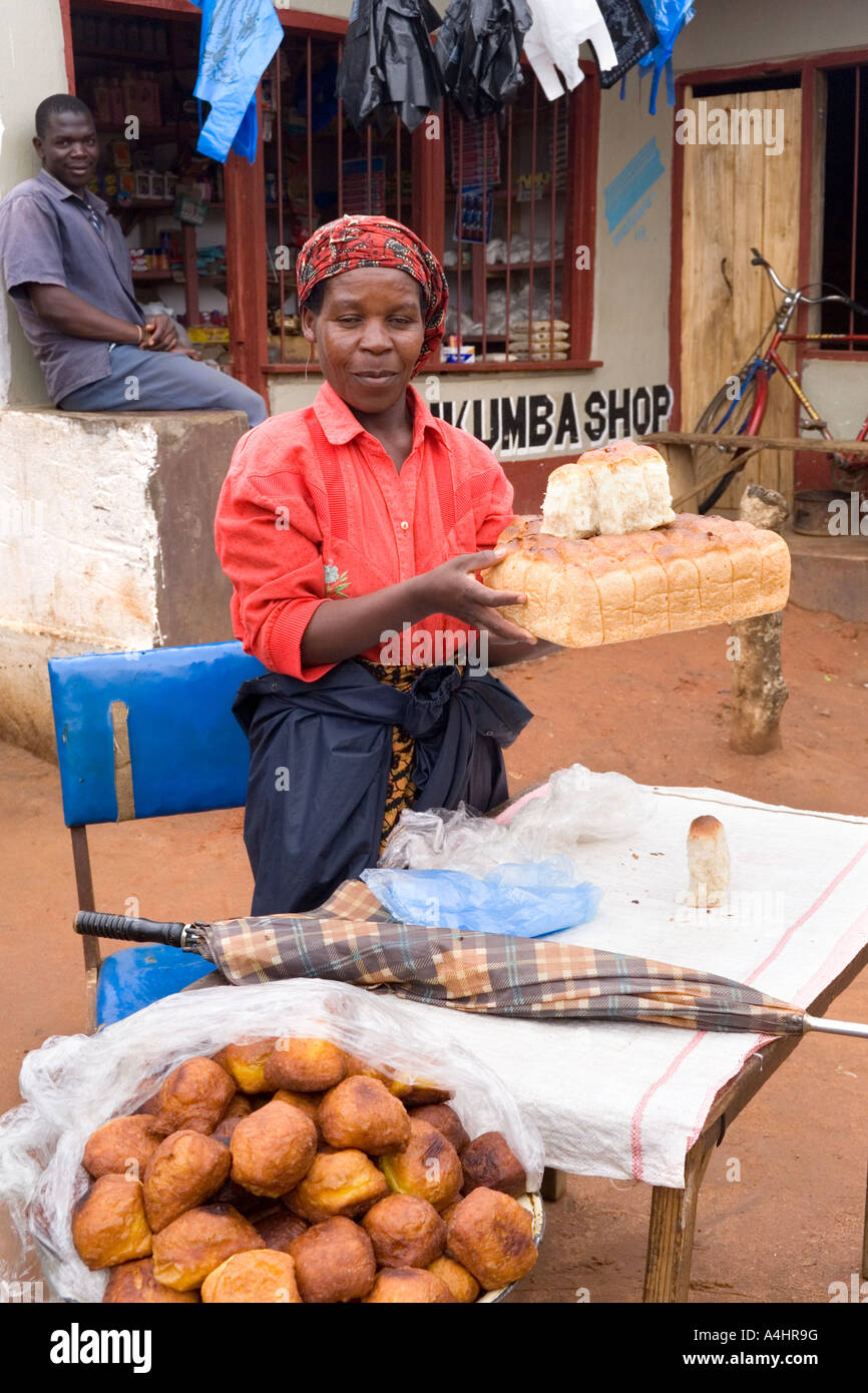 A lady selling doughnuts and bread buns at Nsalu (Nsaru) market Malawi ...