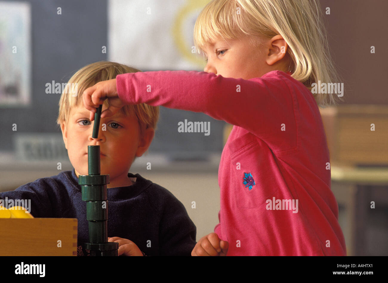 Caucasian preschool students building tower in class Stock Photo - Alamy