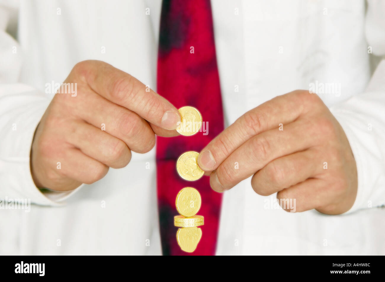 Man balancing coins Stock Photo - Alamy
