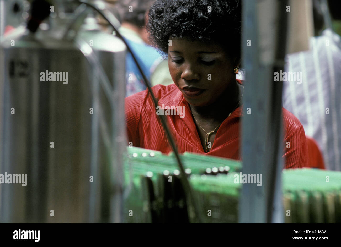 African American factory worker on a circuit board assembly line Stock ...