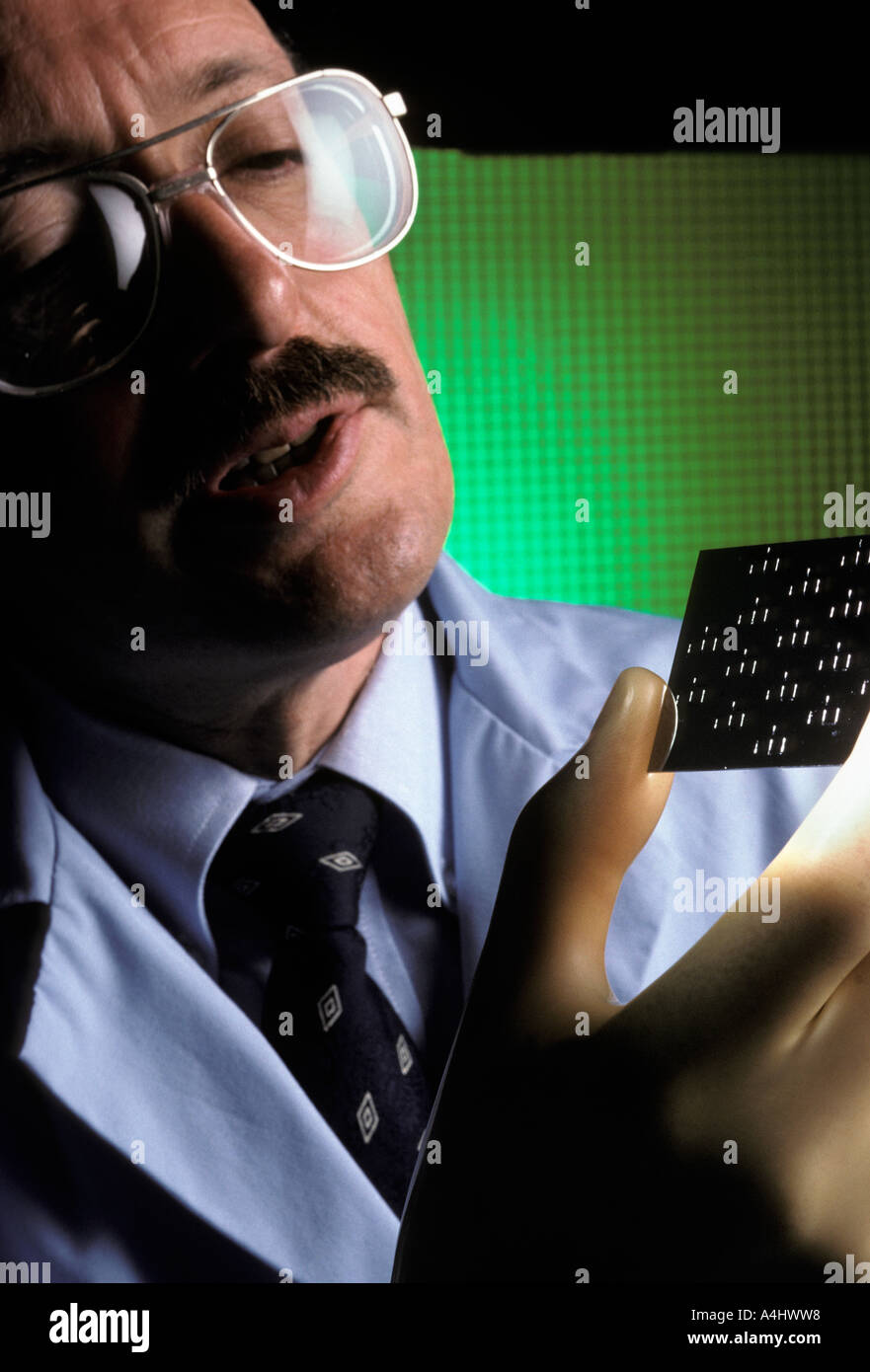 portrait Scientist demonstrating micro electronic device using thin ...