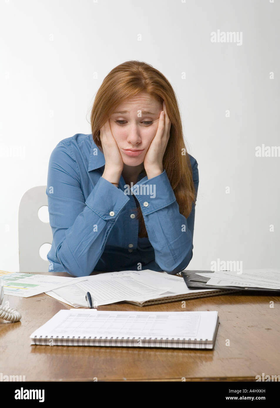 Bored woman at her desk Stock Photo - Alamy