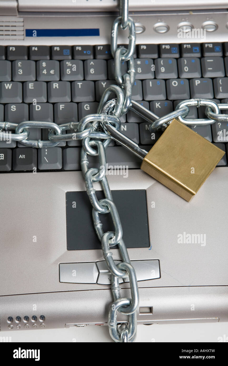 Portable computer wrapped in chains Stock Photo - Alamy
