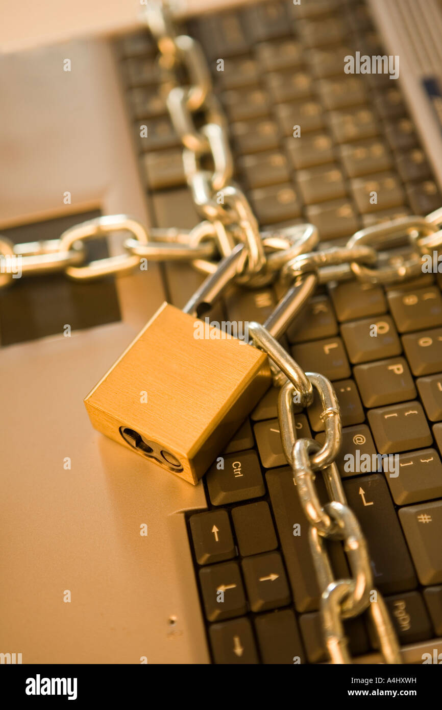 Portable computer wrapped in chains Stock Photo - Alamy