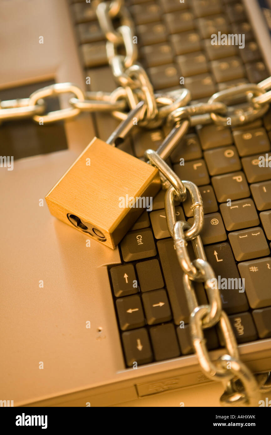 Portable computer wrapped in chains Stock Photo - Alamy