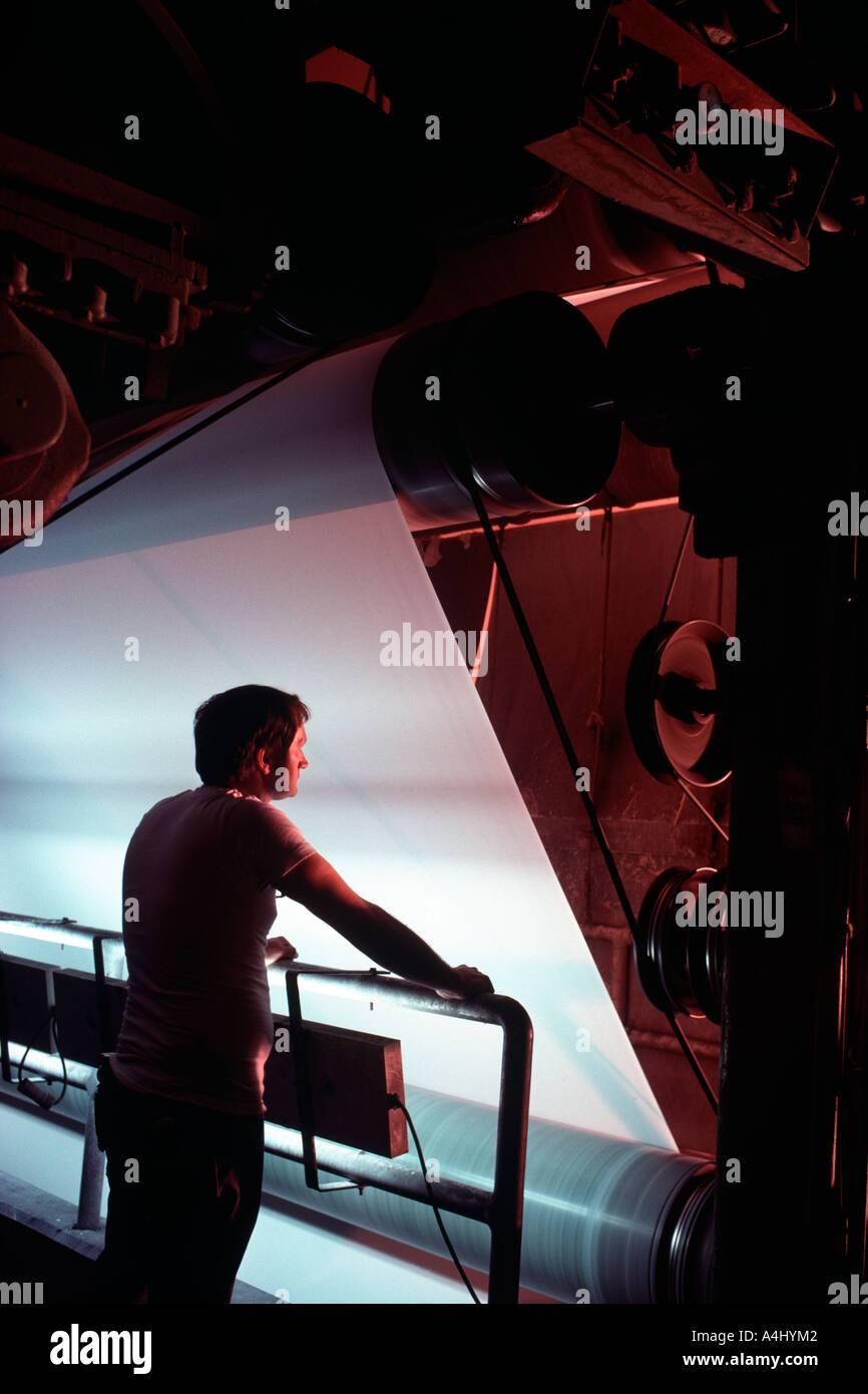 Male worker checking paper making process Stock Photo - Alamy