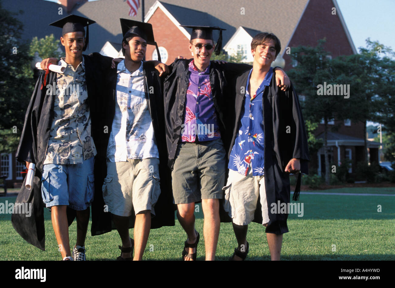 Group of boys walk together in graduation caps and gowns Stock Photo ...