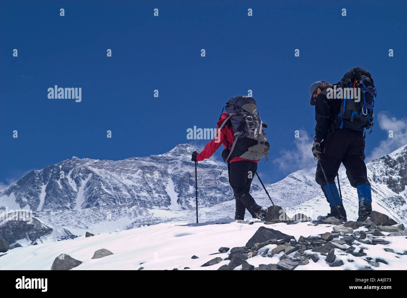 Trekkers hike below the North Face of Mount Everest on the Rongbuk ...