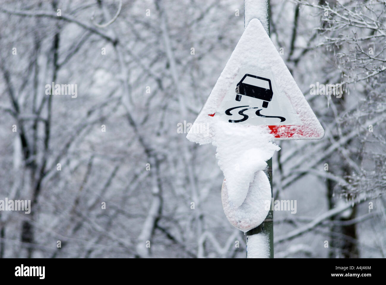 snow covered sign slippery road Germany Stock Photo - Alamy