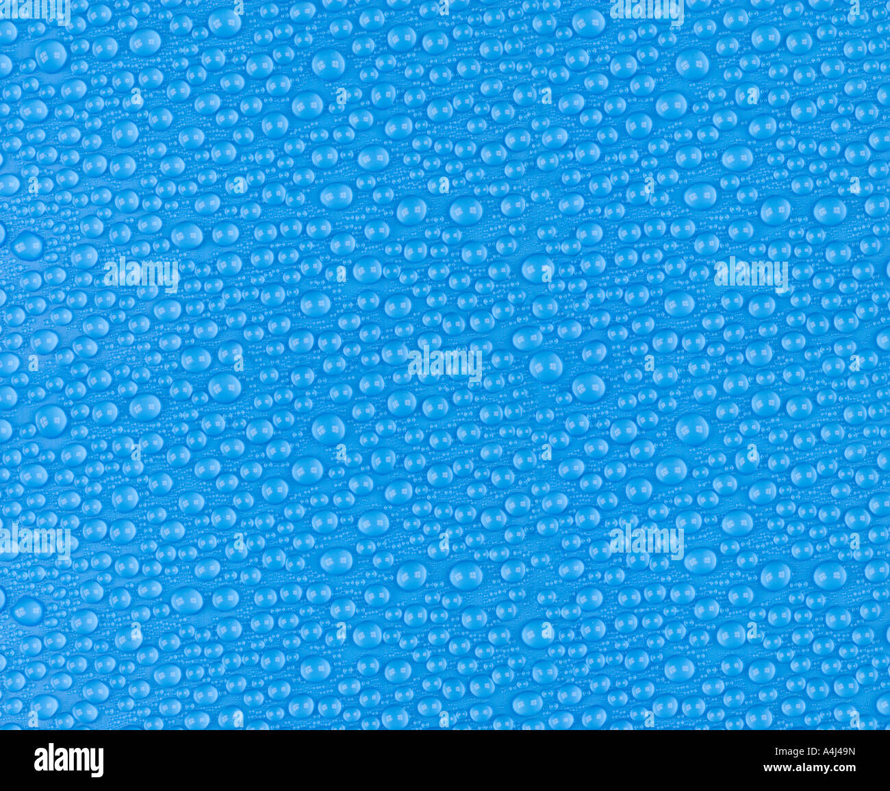 many small blue water drops accumulated on a surface Stock Photo - Alamy
