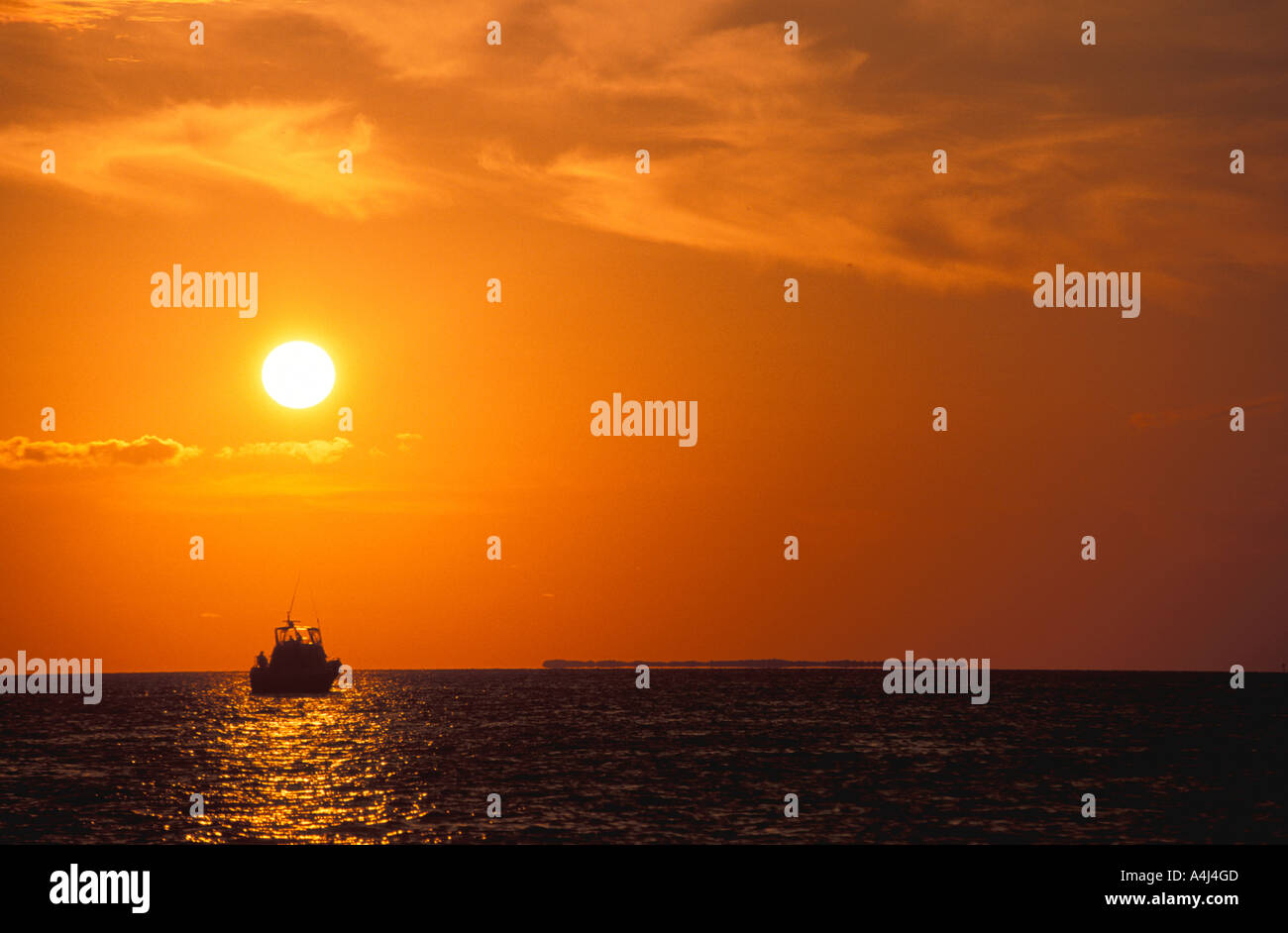 Boating Sunset boat powerboat sunset Stock Photo - Alamy