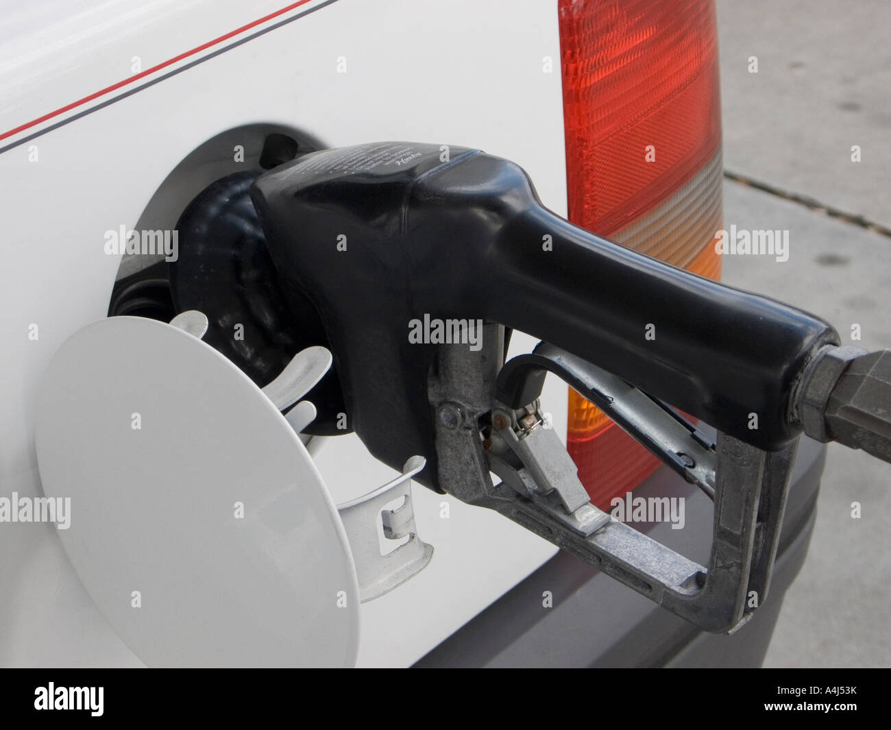 gas nozzle in an automobile gas tank Stock Photo - Alamy