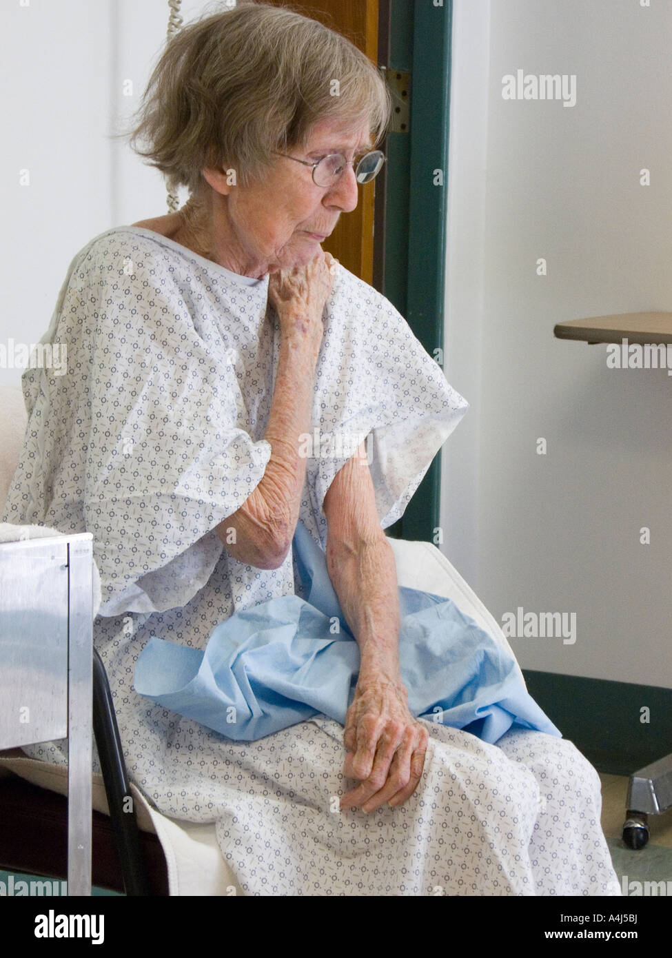exhausted 80 year old woman resting after a whirlpool wound treatment ...