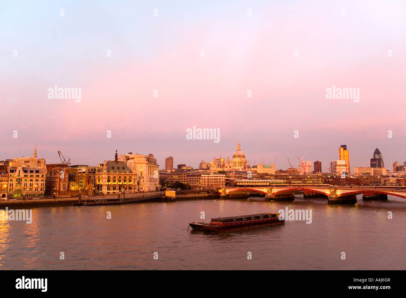 A view of the Thames, Waterloo Bridge and the London skyline at sunset ...
