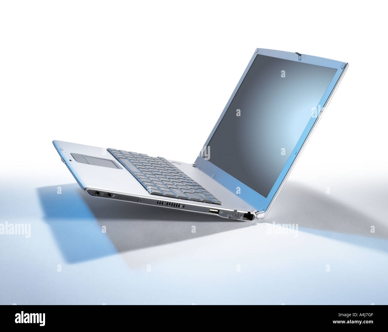 Thin profile laptop computer with colored shadows on a white background ...