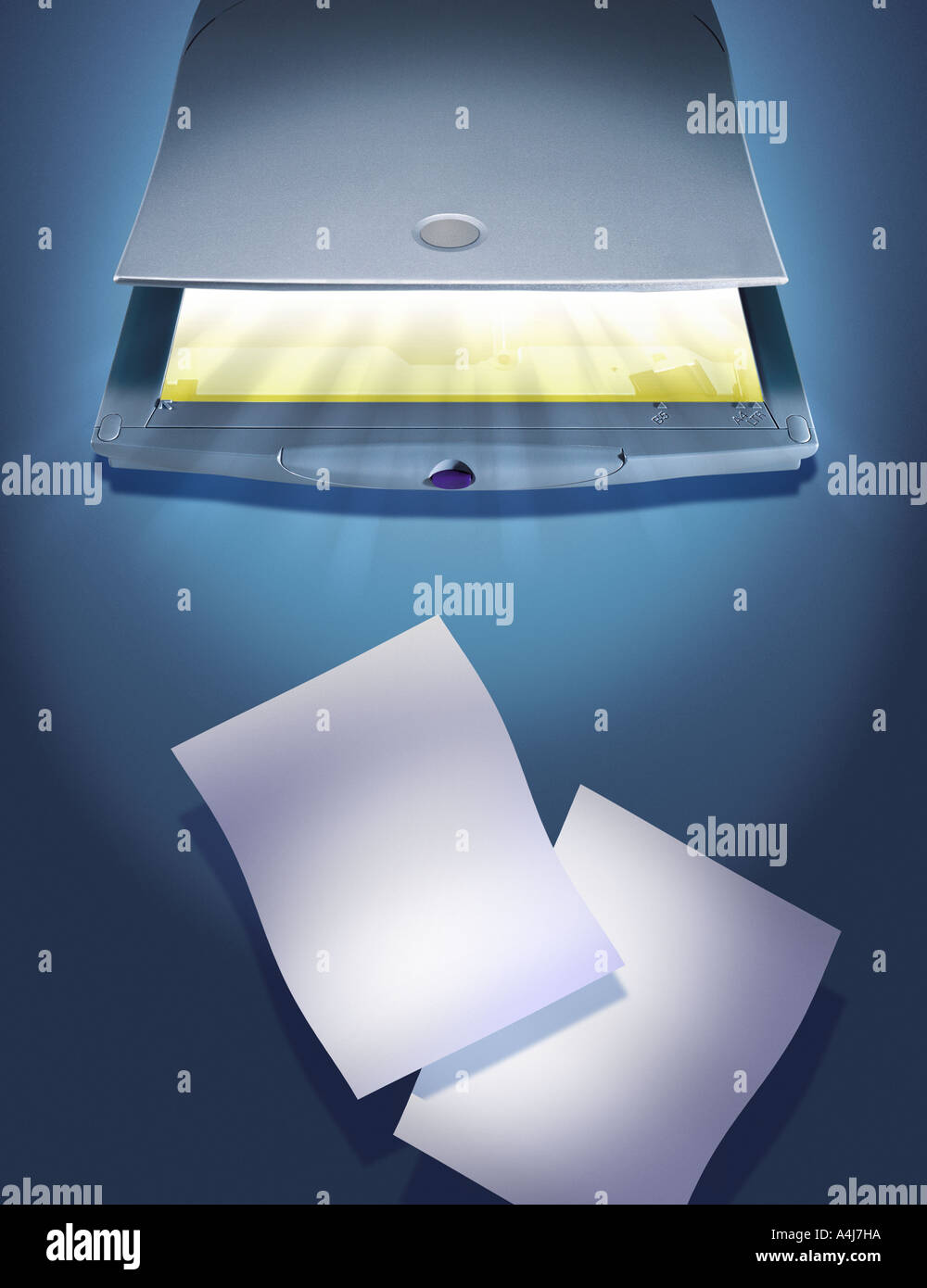 Computer flat bed scanner on a blue background emitting a yellow glow ...