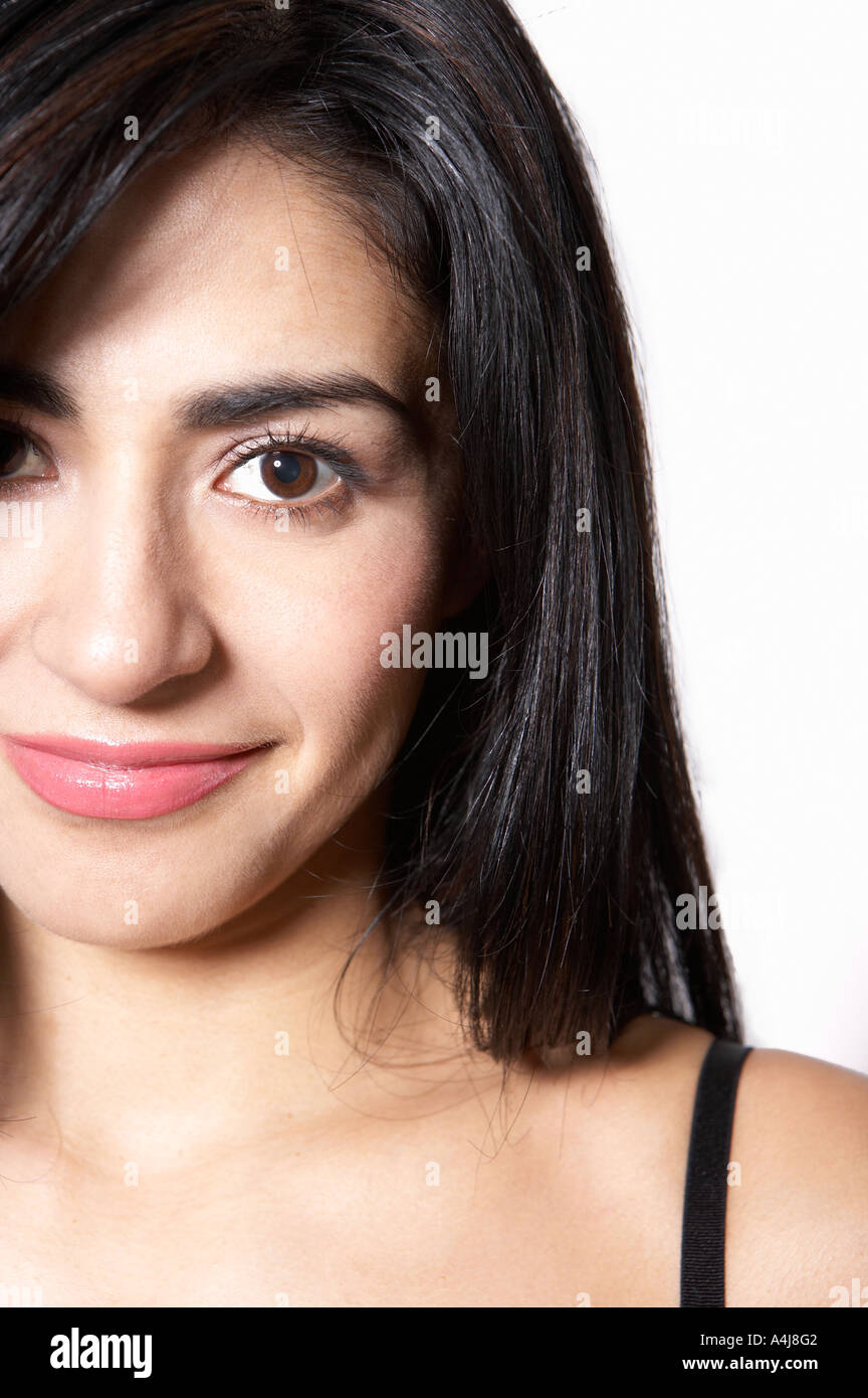Portrait Of Young Woman With Black Hair With A Faint Smile Stock Photo portrait-of-young-woman-with-black-hair-with-a-faint-smile-stock-photo