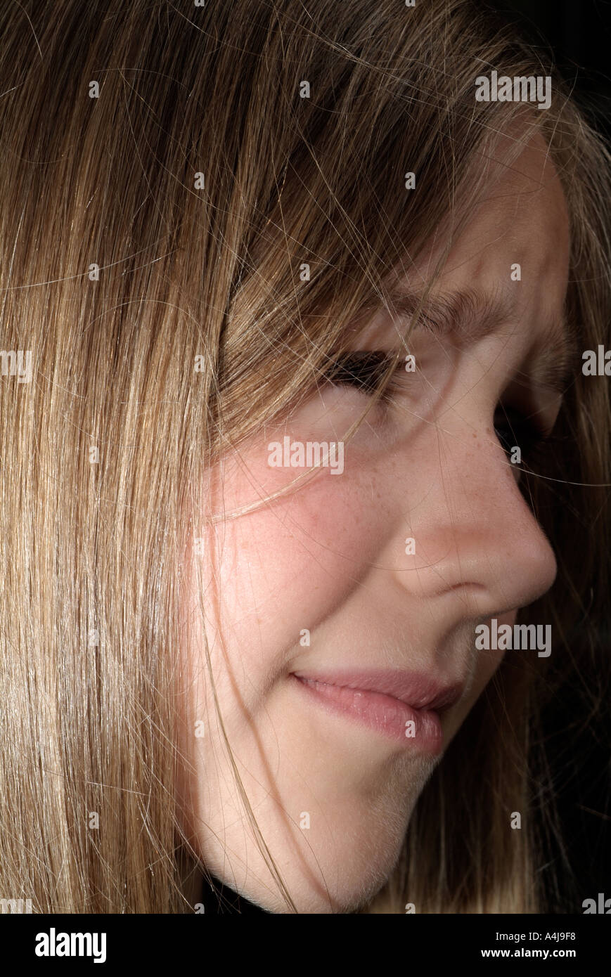 Portrait of a young blond girl with blue eyes smiling Stock Photo - Alamy