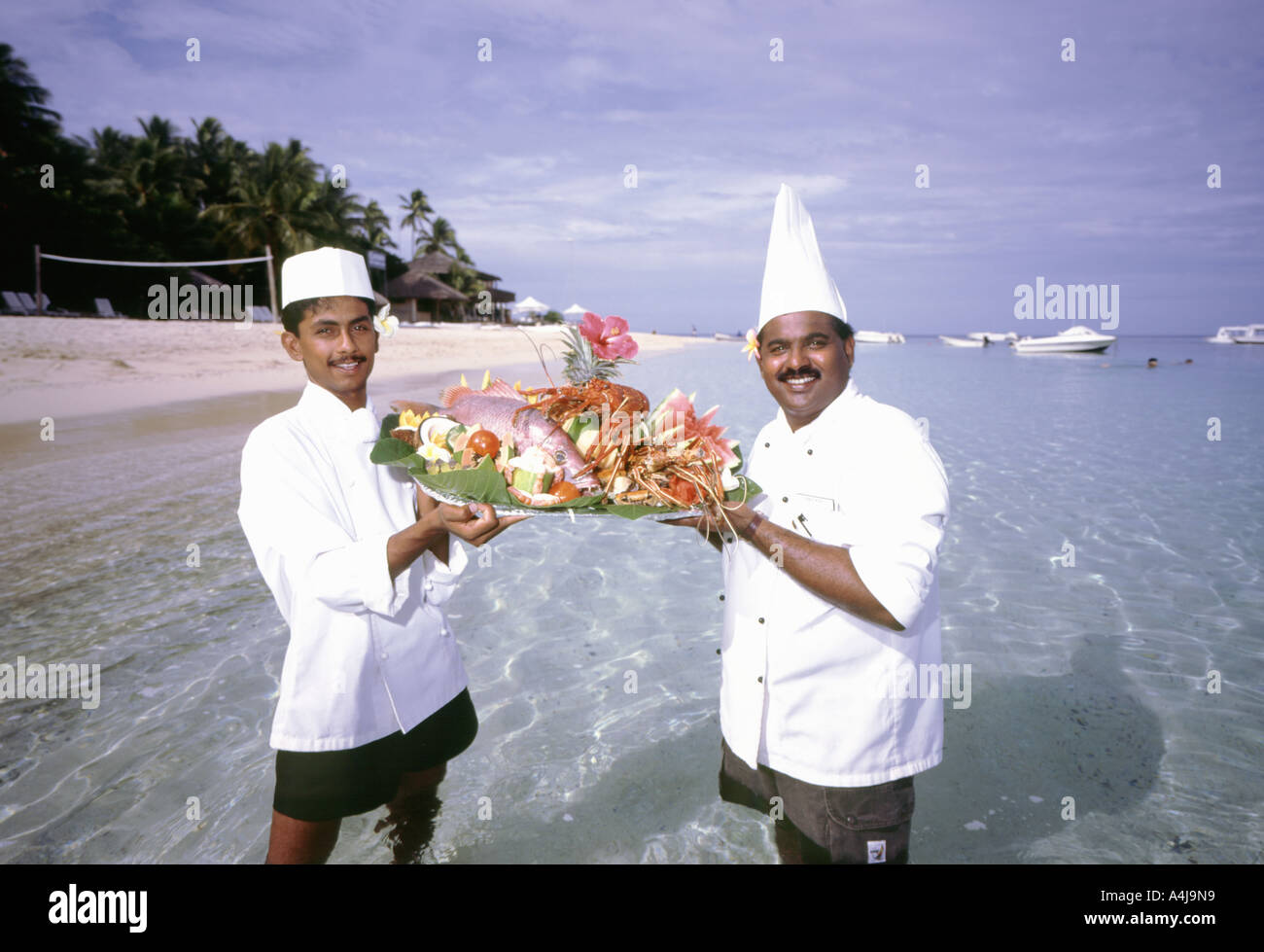 Two chefs holding seafood platter Castaway Island Fiji South Pacific ...