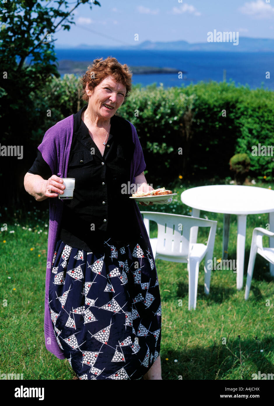 elderly irish woman with glass of milk and sandwich in her hand Stock ...