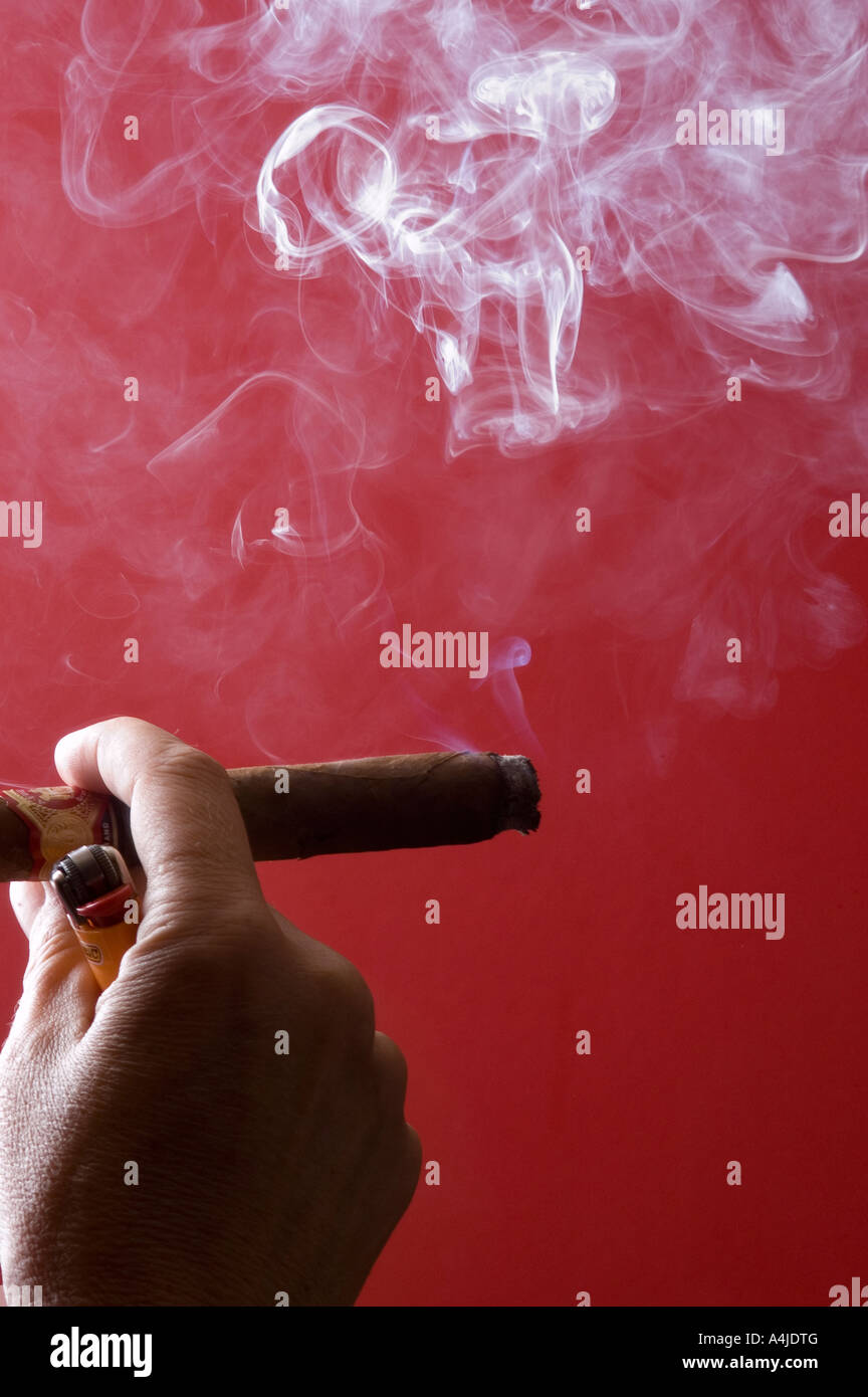 Cigar Smoke with Hand Against a Red Background Stock Photo - Alamy