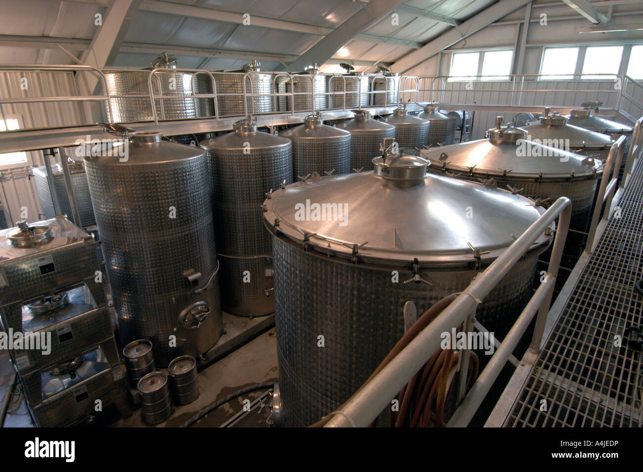 Stainless steel wine vats inside winery Stock Photo - Alamy