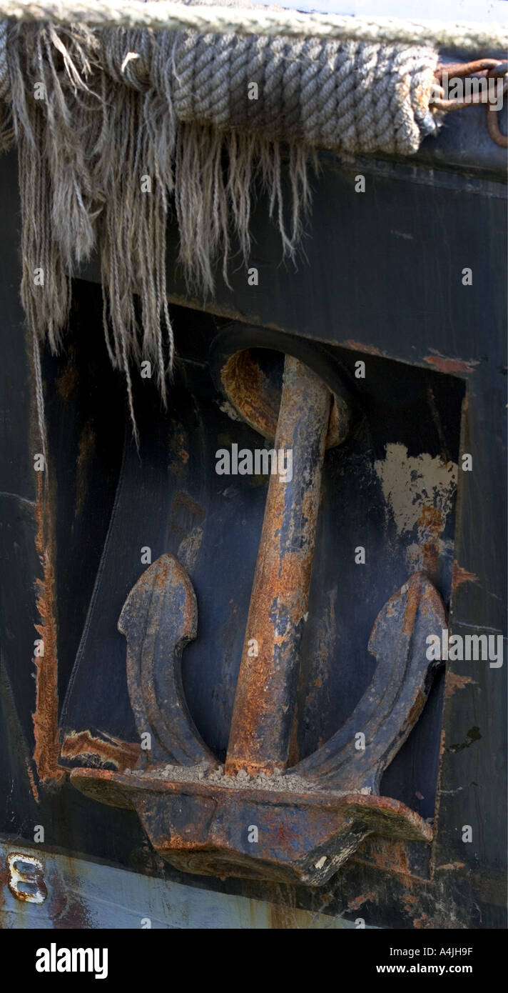 The rusting anchor of a black boat Stock Photo - Alamy