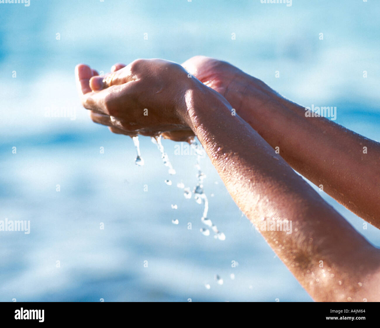Young woman's hands dropping water Stock Photo - Alamy
