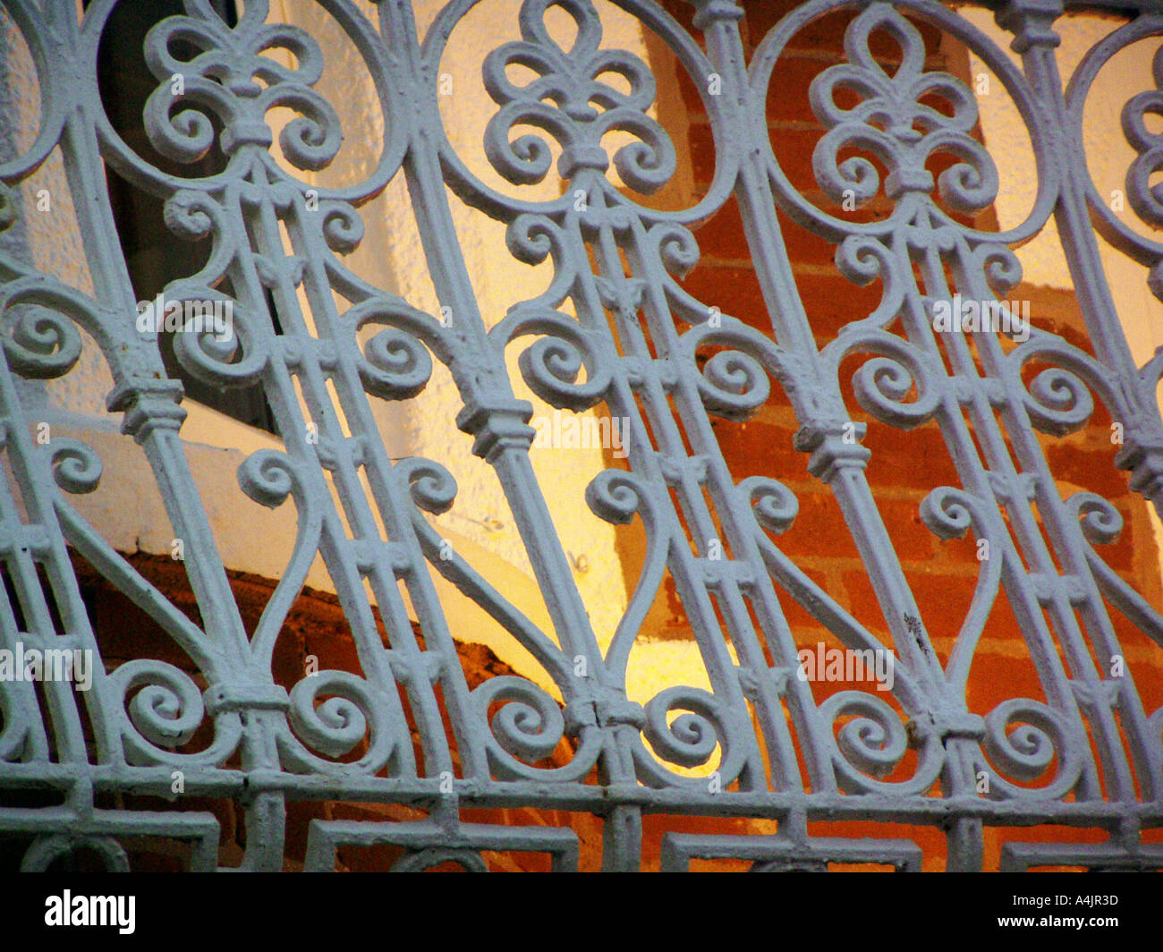 Ornate angled pale blue balcony railing curved surreal red brick white ...