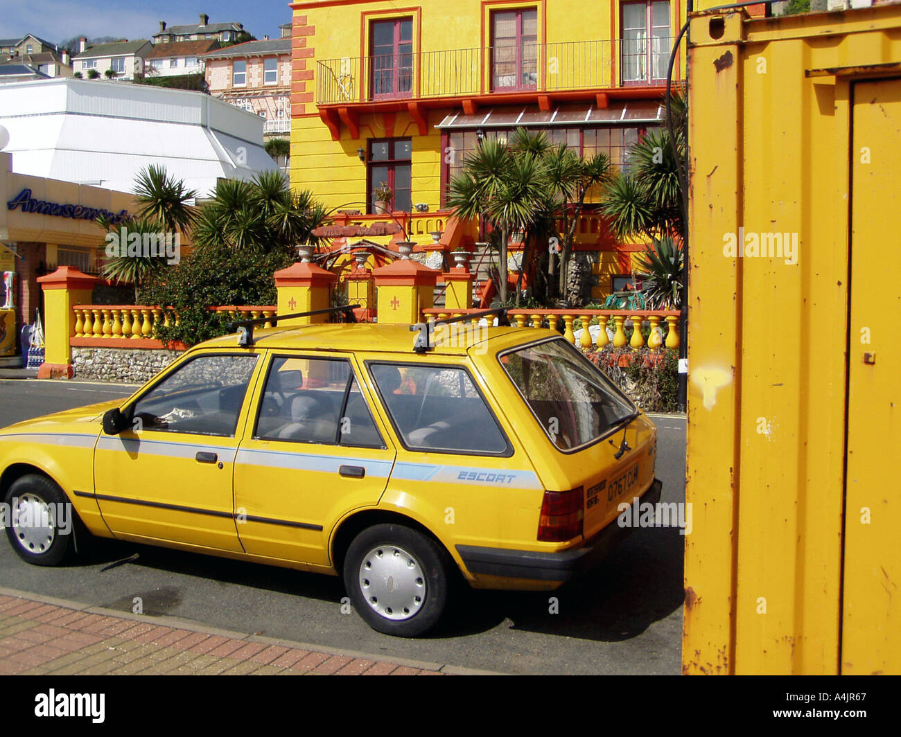 yellow car with yellow house with yellow skip Stock Photo - Alamy
