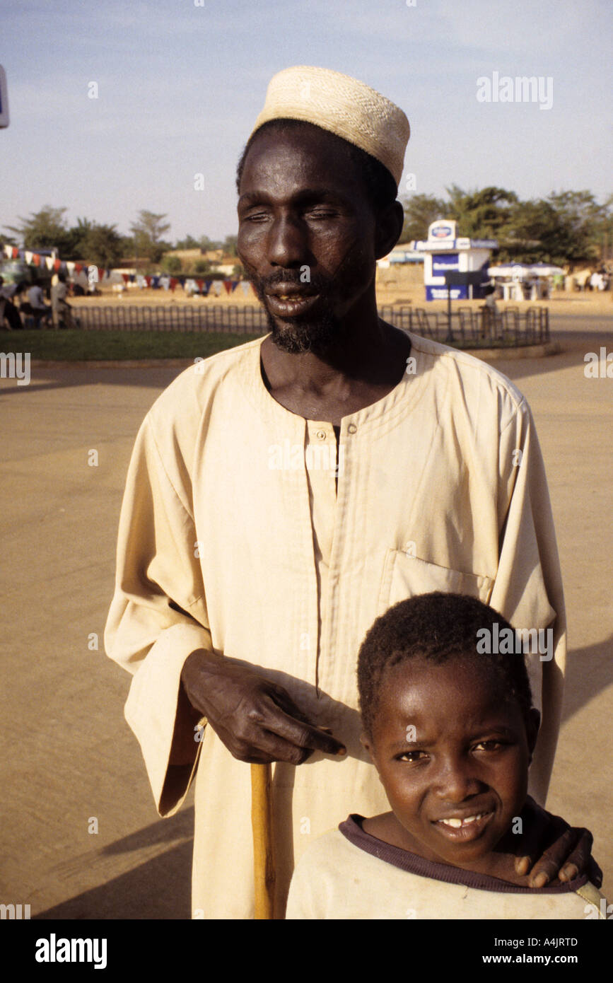 Boy Leading Blind Man, Niger Stock Photo - Alamy