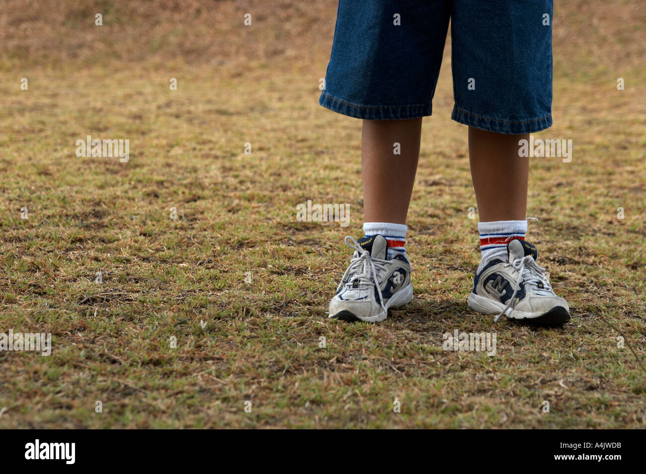 Kid legs wearing shorts and sneakers Stock Photo - Alamy