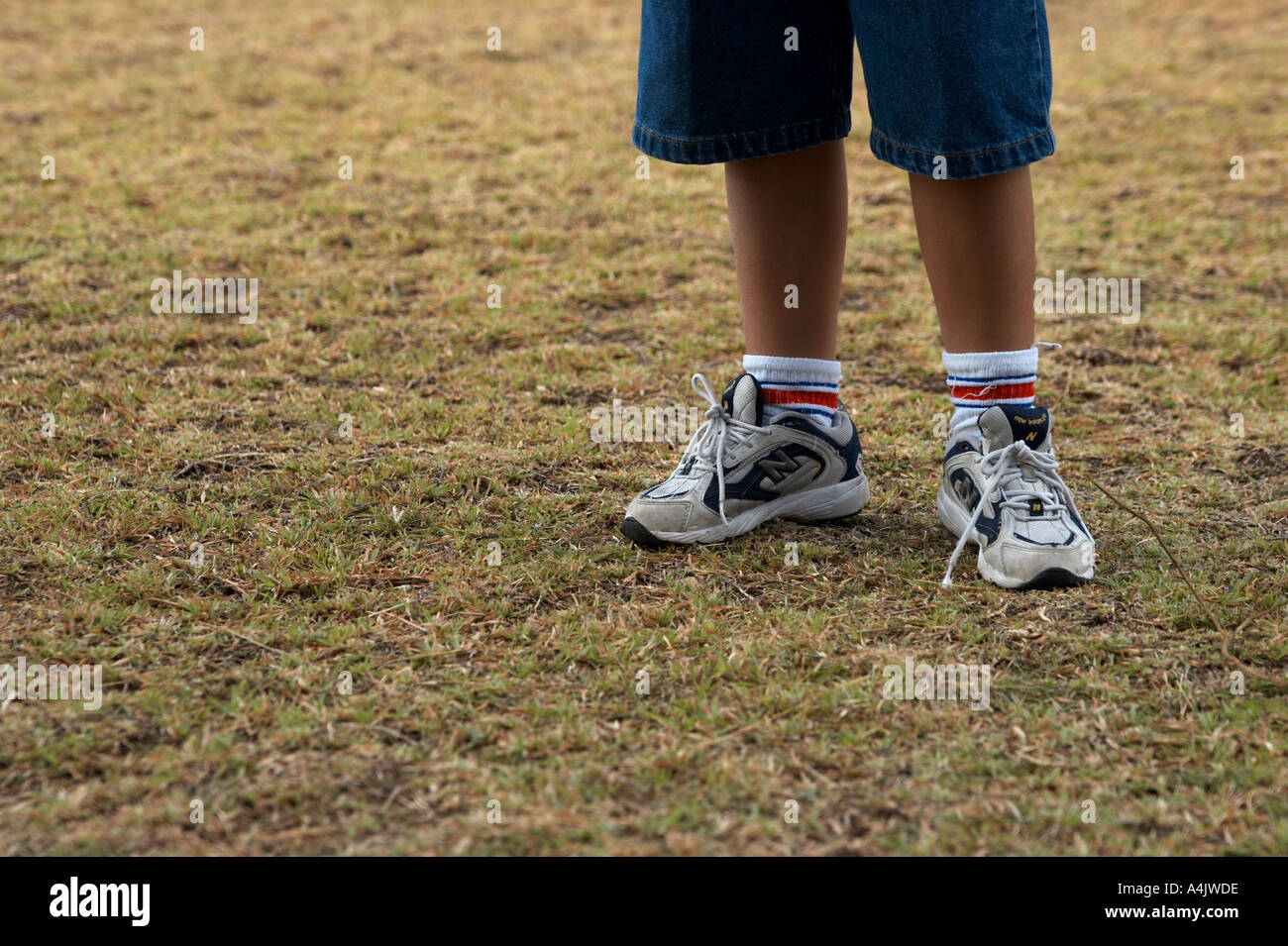 Kid legs wearing shorts and sneakers Stock Photo - Alamy