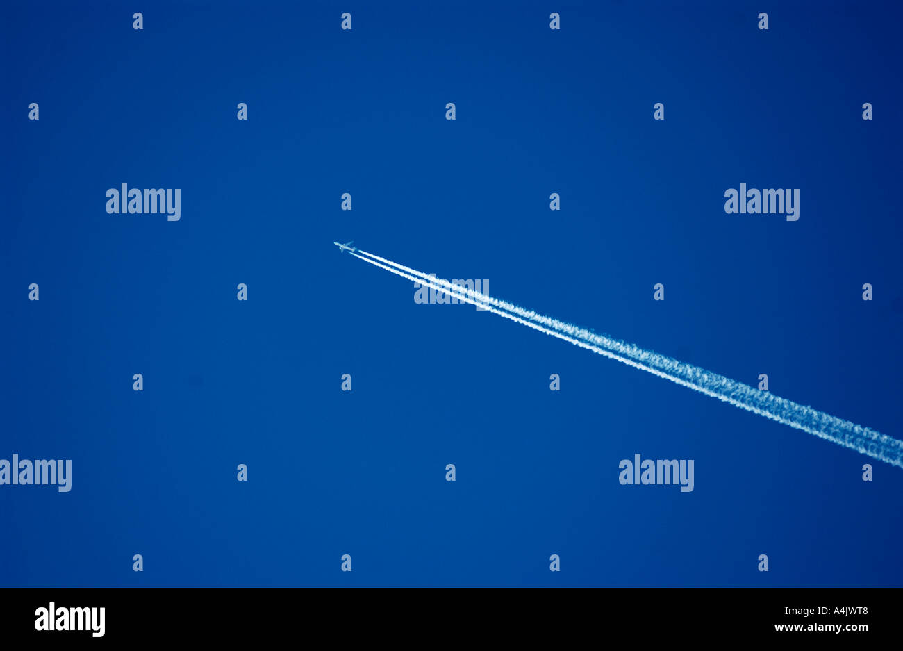 Plane in a blue sky Stock Photo - Alamy