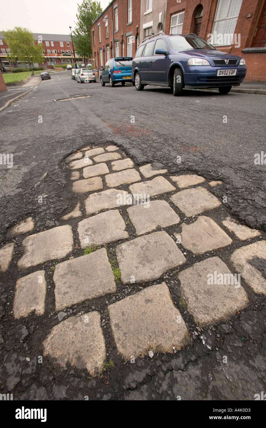 potholes in street with old cobbles below Stock Photo - Alamy