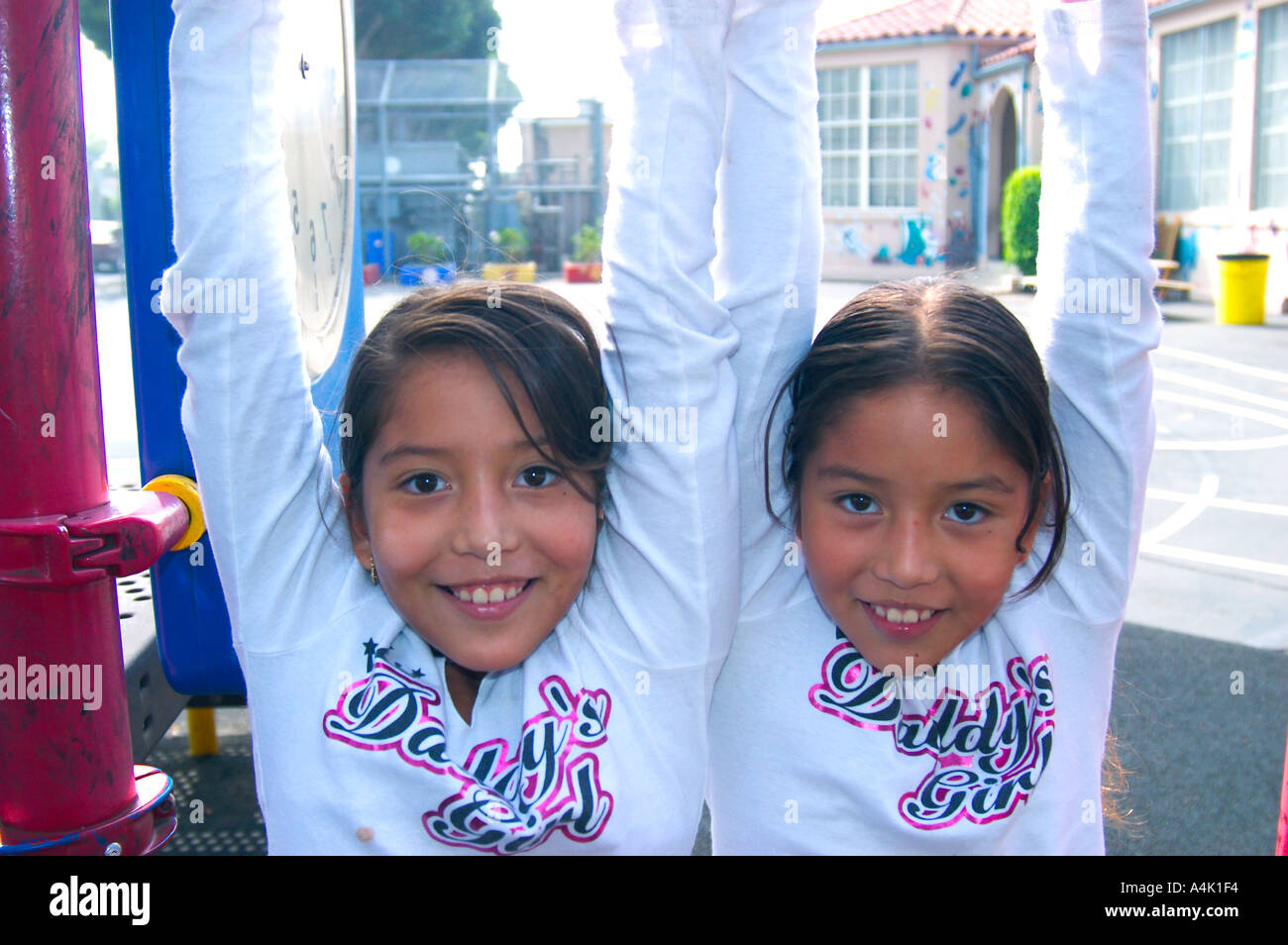 Hispanic twins together Stock Photo - Alamy