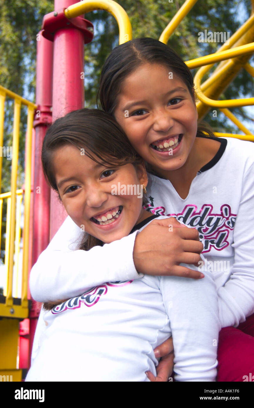 Hispanic twins together Stock Photo - Alamy