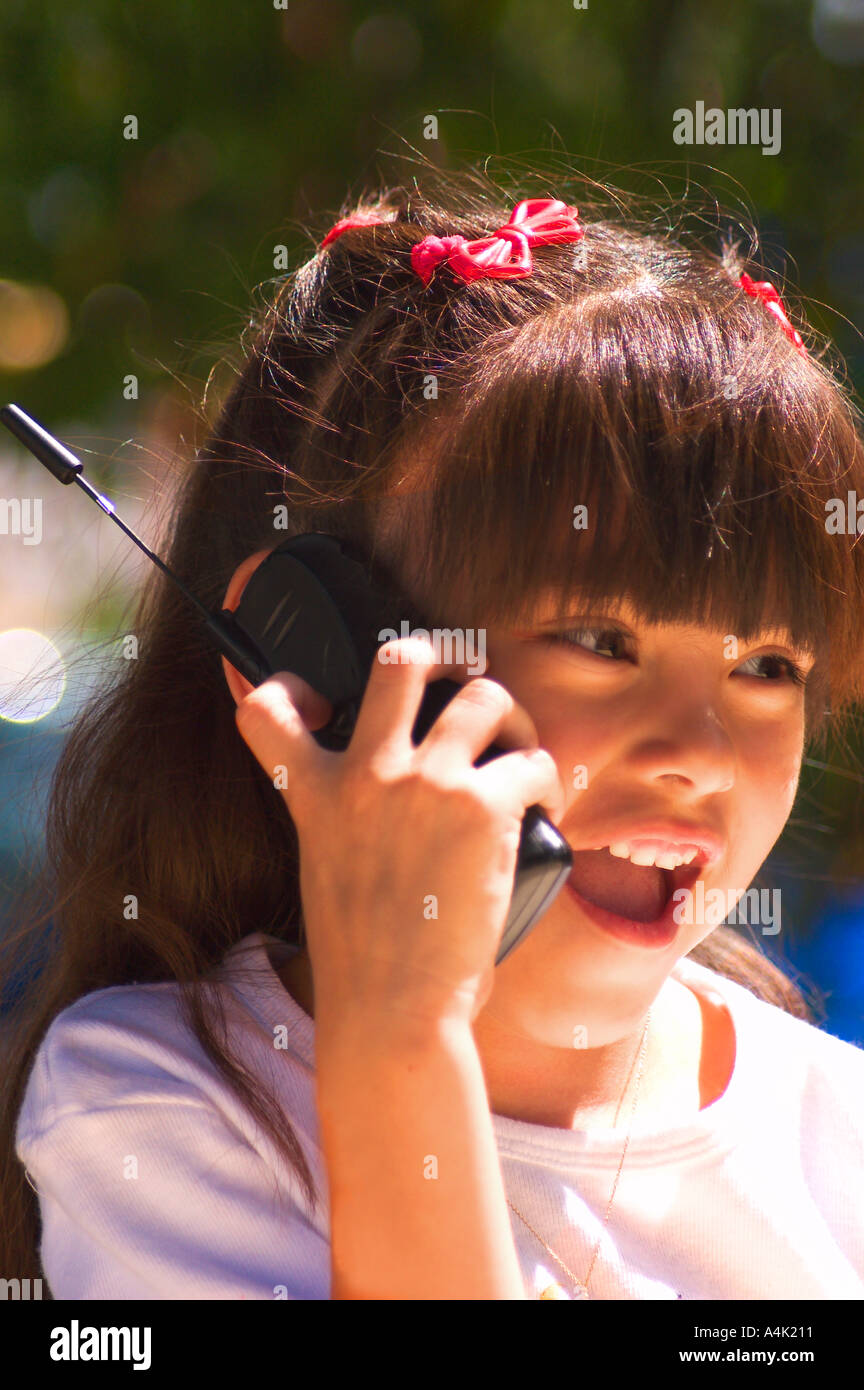 Hispanic young girl talking on phone Stock Photo - Alamy