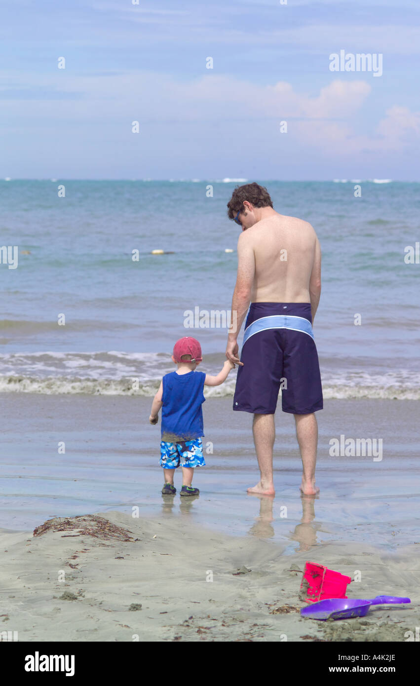 Father and son looking out on the Atlantic ocean from a Puerto Rican ...