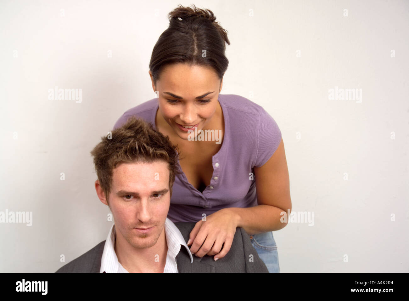 man with a women looking over his shoulder Stock Photo - Alamy