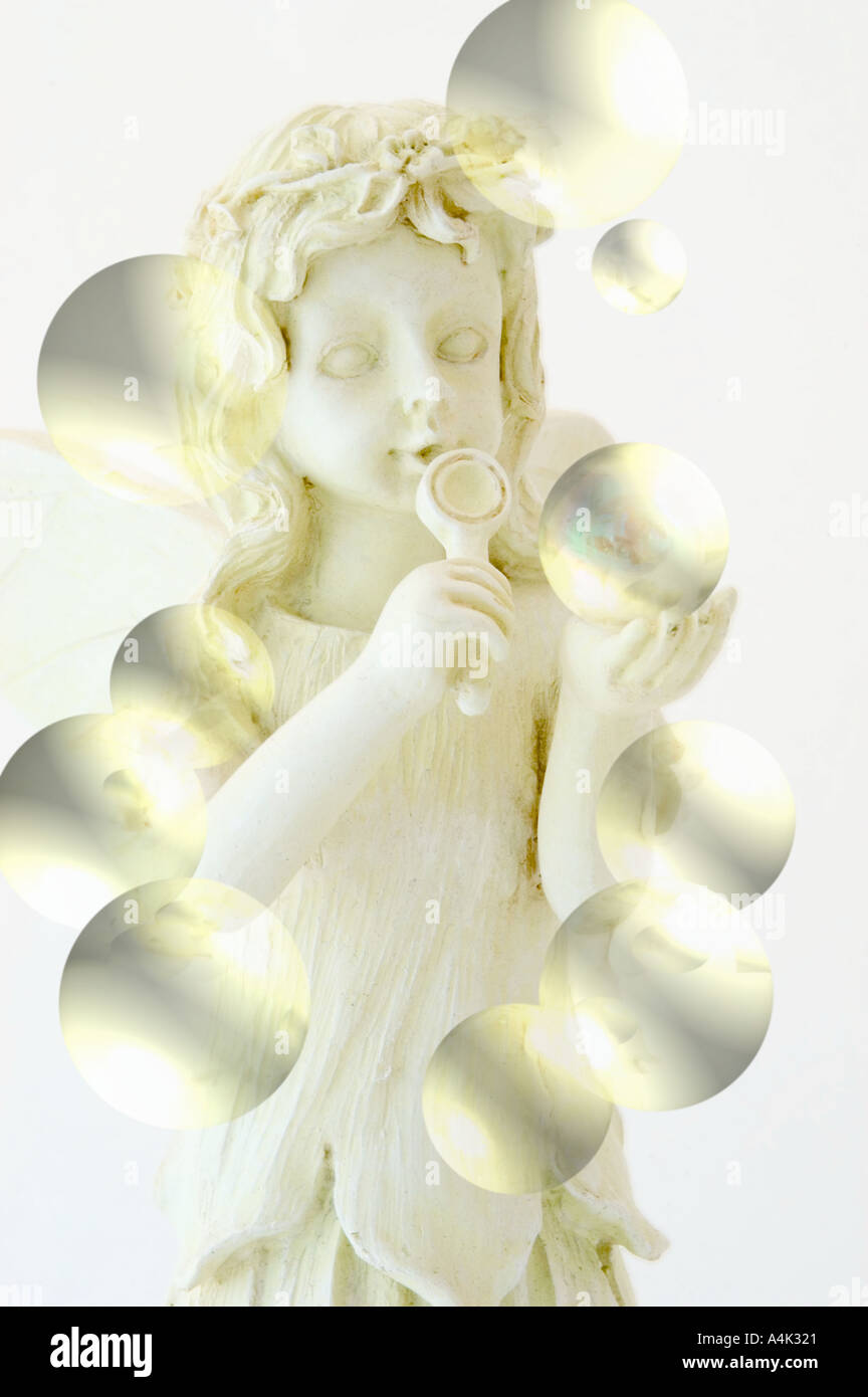 Statue of fairy blowing bubbles with additional bubbles Stock Photo - Alamy