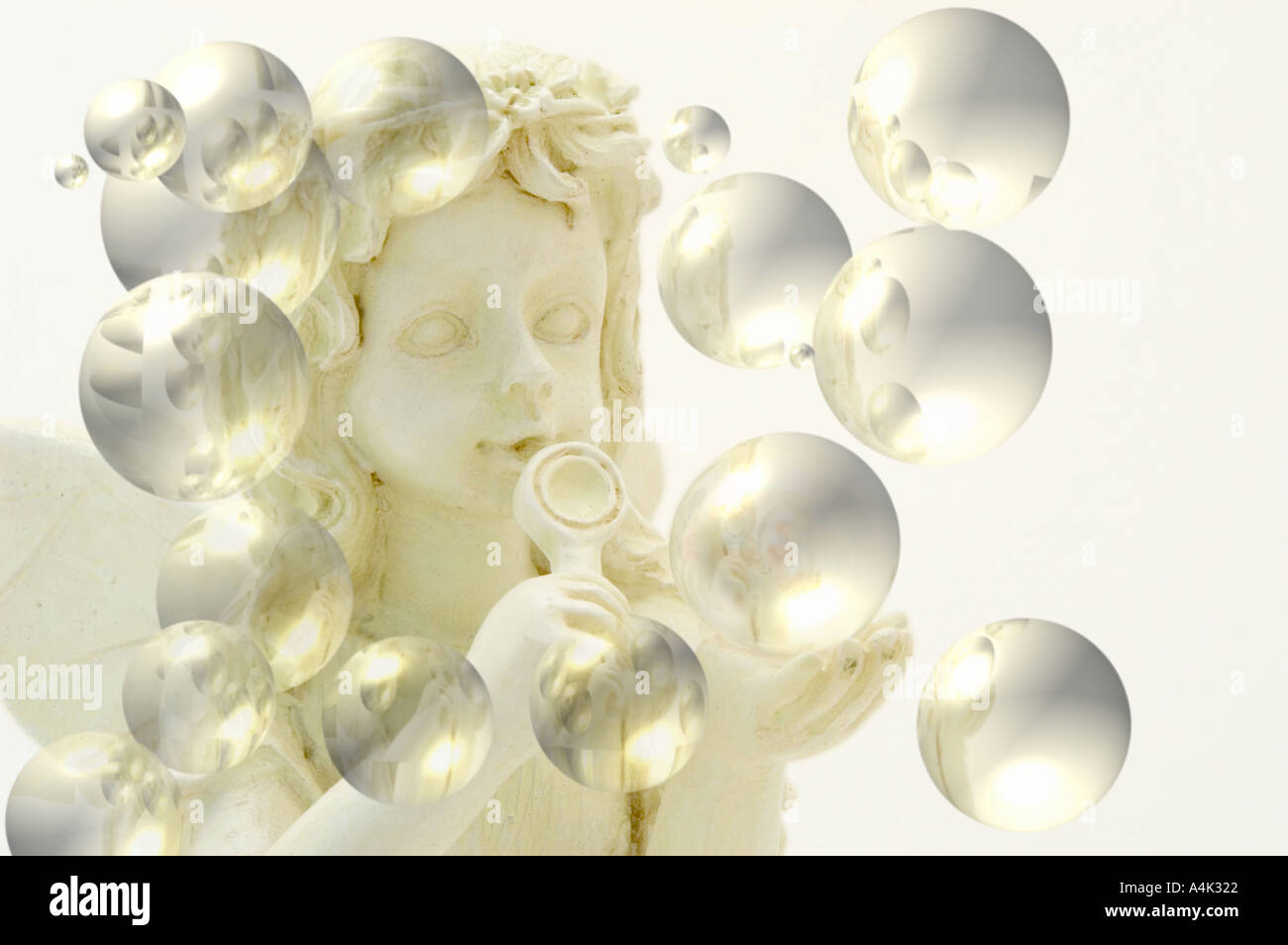 Statue of fairy blowing bubbles with additional bubbles Stock Photo - Alamy
