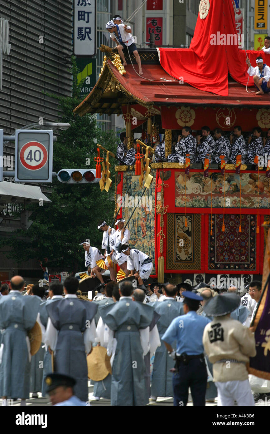 A gion Matsuri festival float is pulled through the modern day streets ...